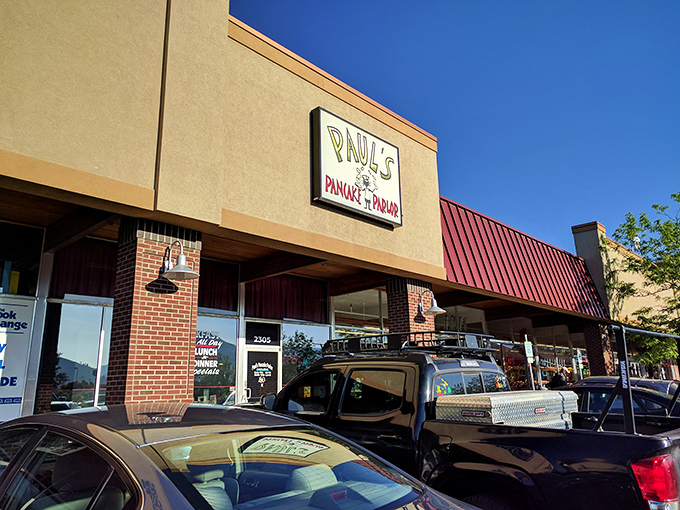 Morning sunshine illuminates Paul's iconic sign, beckoning hungry travelers like a breakfast lighthouse guiding ships to syrupy shores.