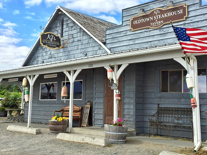 The weathered shingles and American flag say "Alaska," but that porch practically whispers "come in, sit down, and stay awhile."