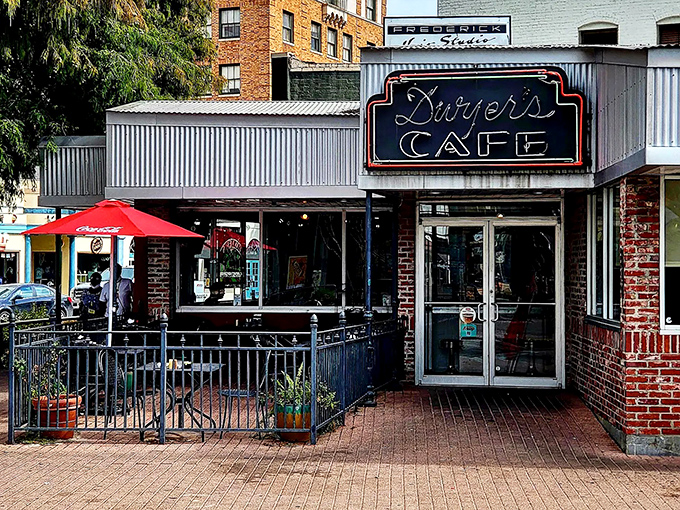 The iconic storefront of Dwyer's Cafe stands as a beacon of breakfast hope in downtown Lafayette, with its classic neon sign promising comfort inside.