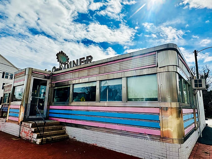 The gleaming stainless steel exterior of Salem Oak Diner stands as a time capsule of Americana, its blue stripe a roadside beacon for hungry travelers.