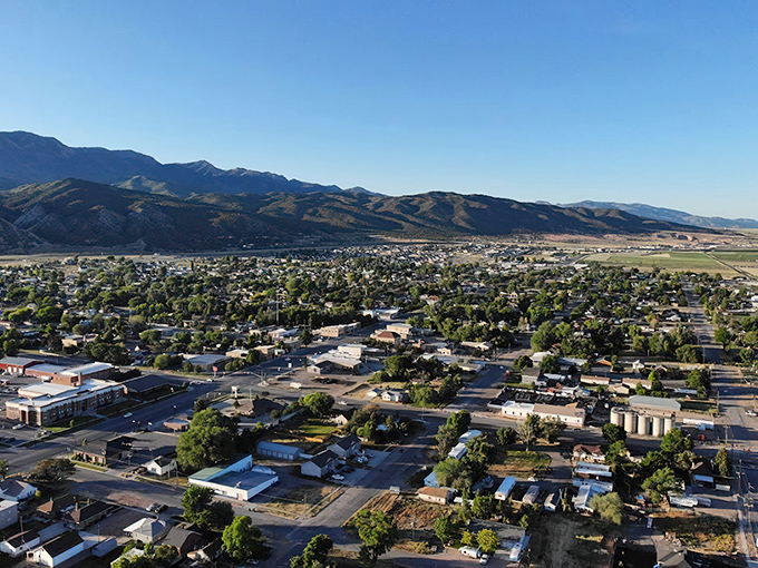 From this aerial view, Nephi unfolds like a patchwork quilt of homes, businesses, and greenery against the mountain backdrop.