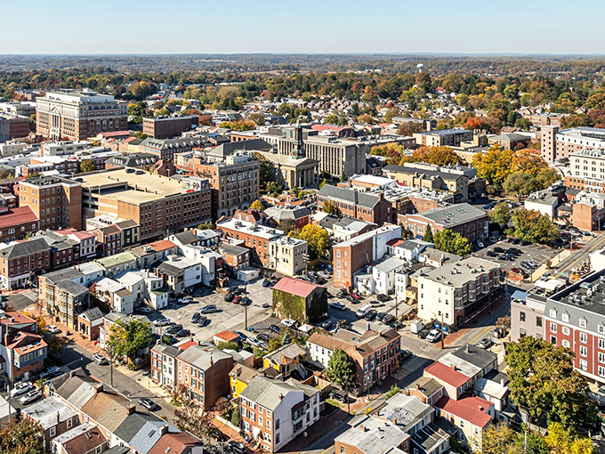The brick-laden cityscape of West Chester spreads out like a historical tapestry, with church spires and university buildings punctuating the skyline against autumn's golden backdrop.
