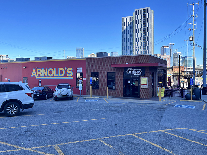 Arnold's brick exterior stands like a culinary lighthouse against Nashville's modern skyline, promising comfort food salvation to hungry souls.
