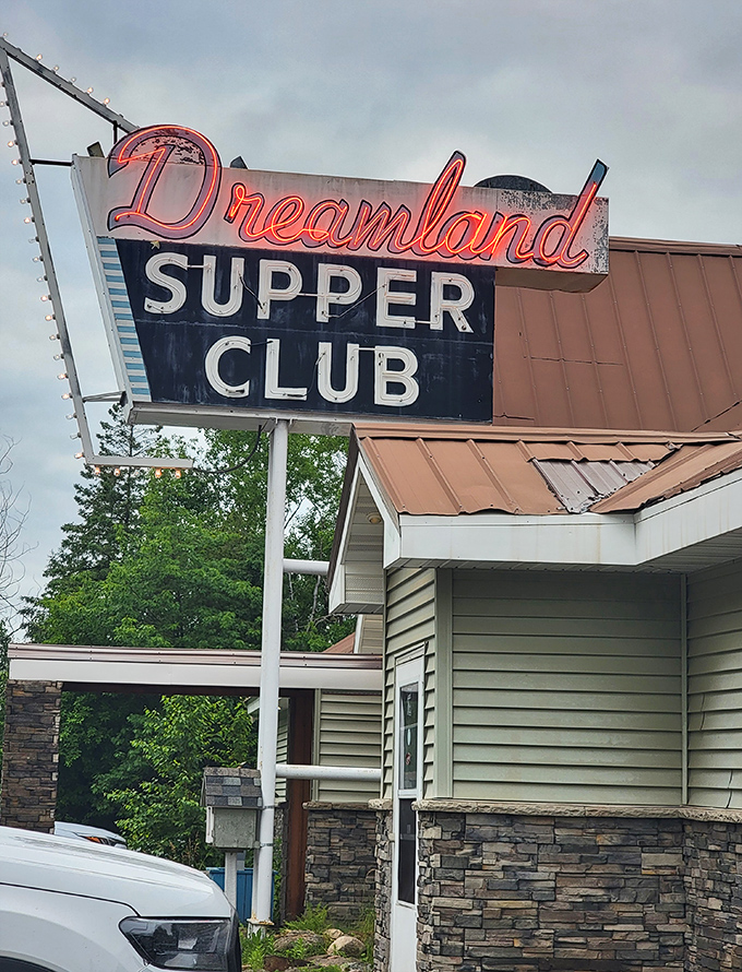 The classic neon sign glows like a beacon in the Wisconsin northwoods, promising lobster dreams and old-fashioned hospitality.