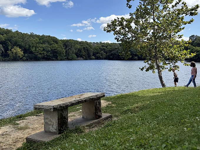 A stone bench overlooking Lake Macbride's serene waters – nature's version of front-row seats to the best show in Iowa.