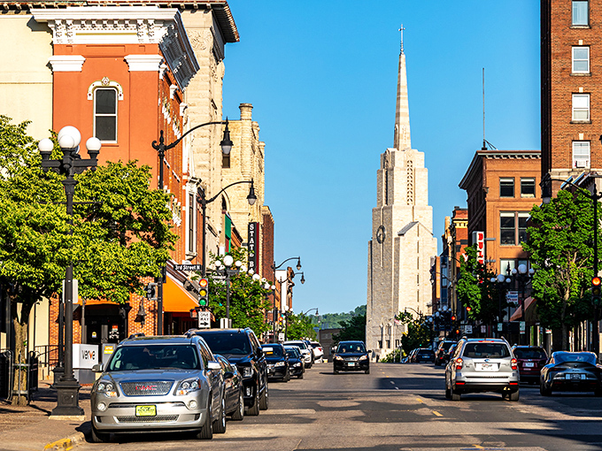 Downtown La Crosse's historic architecture frames the gleaming spire of a church, creating a Norman Rockwell scene where your retirement dollars actually stretch further than your imagination.