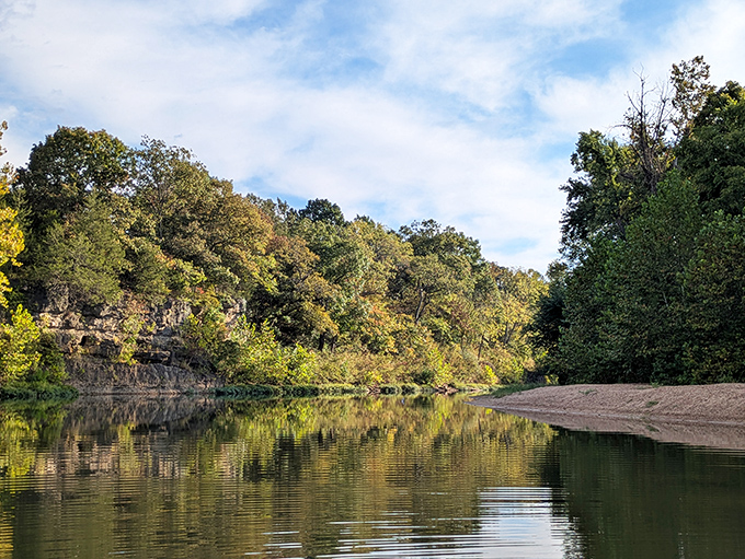 The Big River flows through Washington State Park like nature's mirror, perfectly reflecting the rugged bluffs and lush forests that make this hidden Missouri gem so captivating.