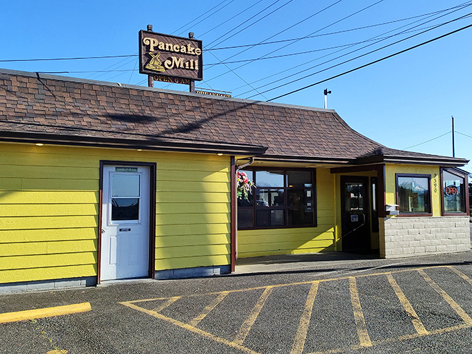 The cheerful yellow exterior of Pancake Mill stands like a breakfast lighthouse on the Oregon coast, beckoning hungry travelers with promises of pancake perfection.