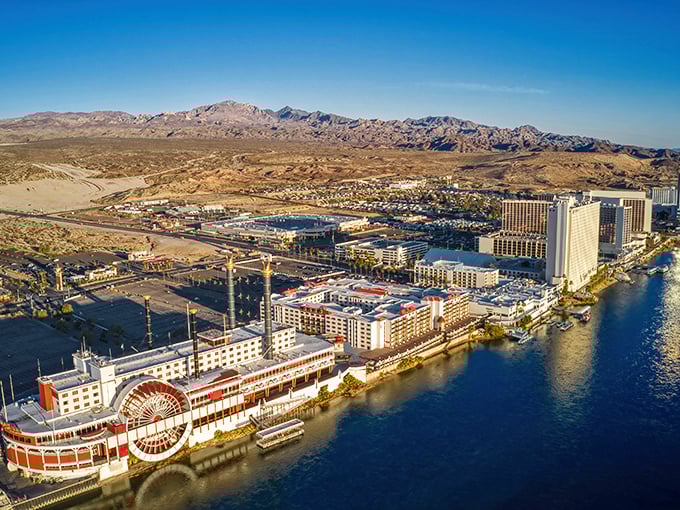 Aerial view of Laughlin's casino row hugging the Colorado River, where desert mountains meet waterfront luxury in a surprisingly serene setting.