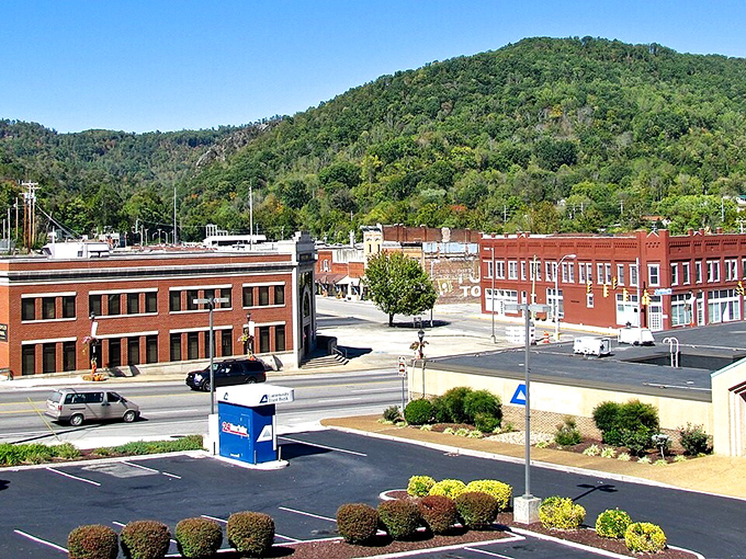 Downtown LaFollette nestled against the Cumberland Mountains, where brick buildings stand proudly against a backdrop of green hills that seem to cradle the town in nature's embrace.