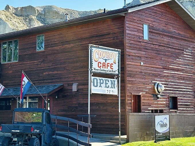The Cowboy Cafe stands like a wooden sentinel against Medora's dramatic badlands, promising hearty meals and authentic western hospitality to weary travelers.