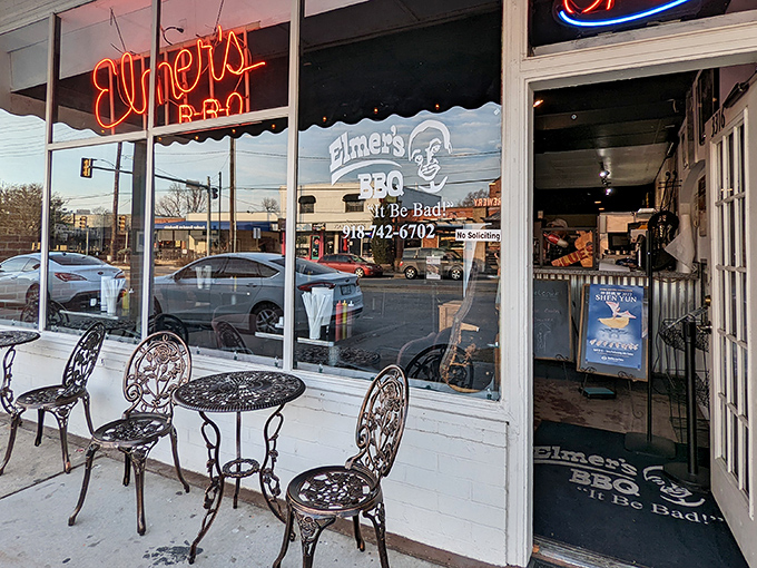 The neon "Elmer's BBQ" sign glows like a beacon for smoke-seekers, while the reflection in the window hints at the treasures waiting inside.