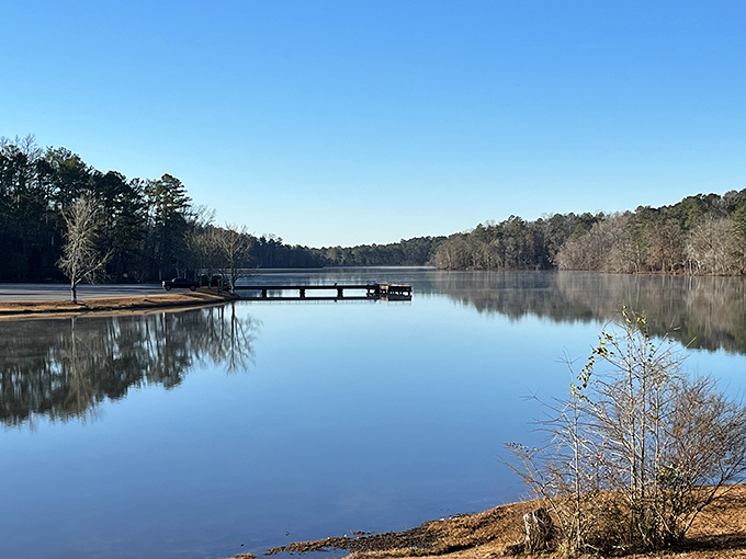 Mirror, mirror on the lake&mdash;Lake Lurleen's glass-like surface reflects Alabama's blue skies and towering pines, creating nature's perfect infinity pool.