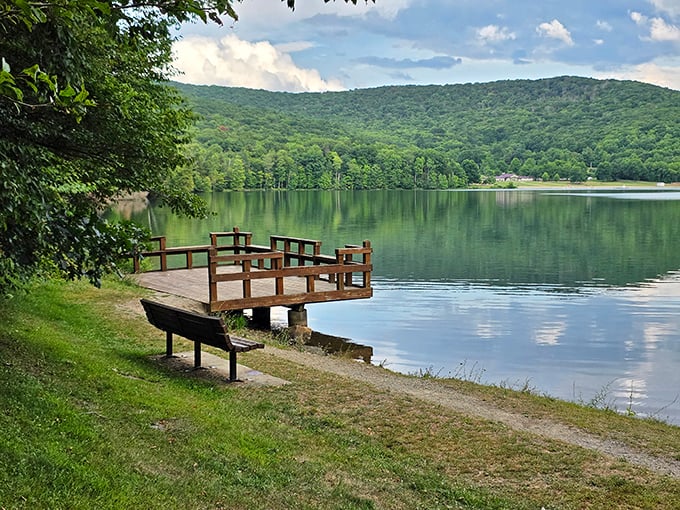 A quiet fishing dock invites contemplation at Allegany's pristine lake. The perfect spot to sit, breathe, and remember what silence actually sounds like.