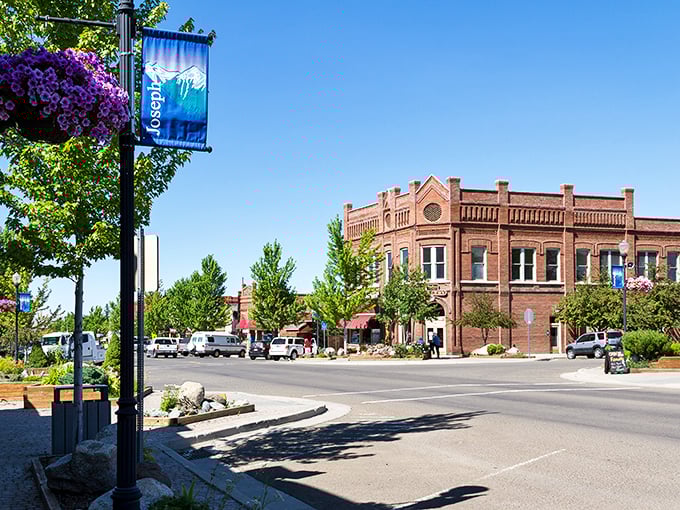 Joseph's historic brick buildings frame a postcard-perfect Main Street, where hanging flower baskets add splashes of purple against the clear blue Oregon sky.