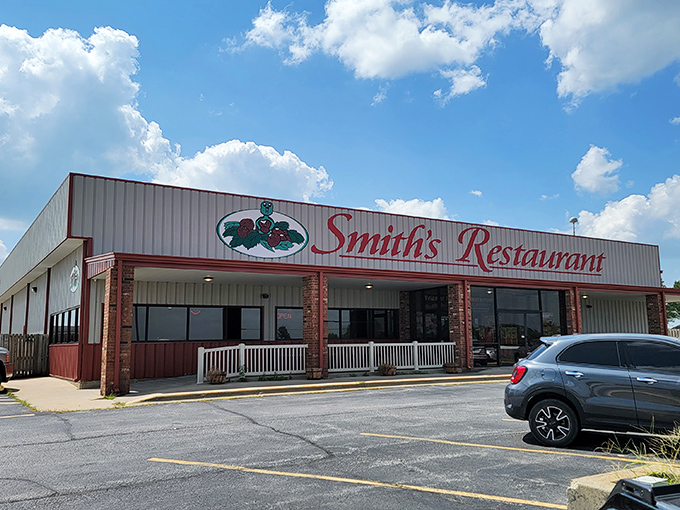 The iconic red script of Smith's Restaurant against a blue Missouri sky promises comfort food paradise within those unassuming walls.