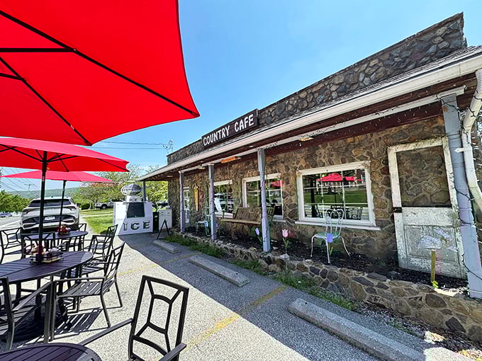 Stone walls that have witnessed thousands of breakfast epiphanies, topped with those cheerful red umbrellas that practically scream "good morning!"
