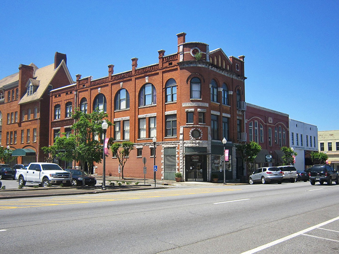 Historic brick buildings line downtown Americus, showcasing the town's preserved Victorian architecture against a brilliant blue sky.