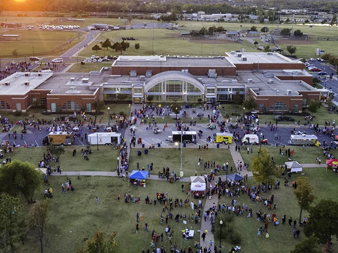Community spirit comes alive during Mustang's town events, where food trucks, families, and Friday night lights transform school grounds into the heart of local celebration.