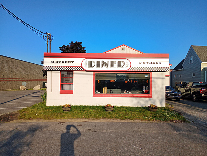 The classic American diner dream &ndash; white walls, red trim, and a sign that promises comfort without pretension.