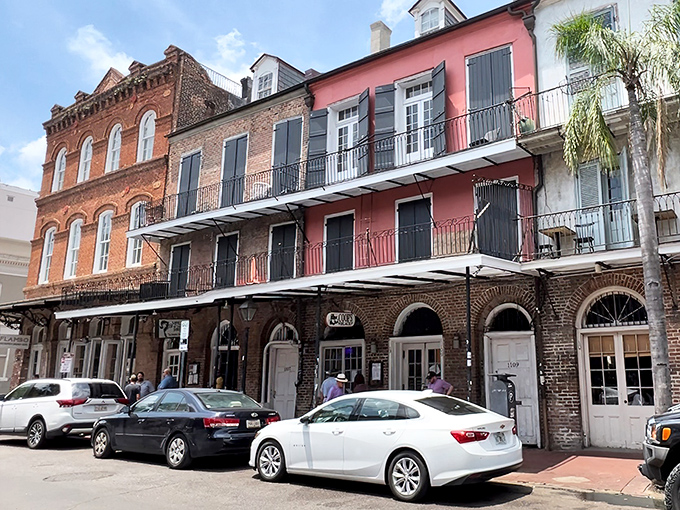 Classic French Quarter architecture houses culinary treasures at Coop's Place, where the pink building next door only hints at the colorful experience awaiting inside.