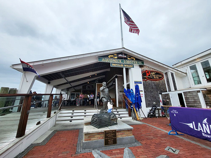 The quintessential New England welcome: weathered shingles, American flag fluttering overhead, and the promise of lobster treasures waiting inside.