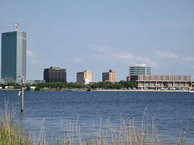 Lake Charles skyline shimmers like a mirage across the water, where retirement dreams and reality meet in perfect Louisiana harmony.