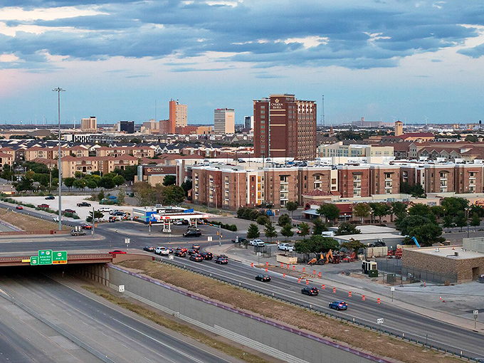 Lubbock's skyline stretches across the horizon like a modest urban island in Texas's sea of plains, where barbecue smoke mingles with cotton-candy clouds at sunset.