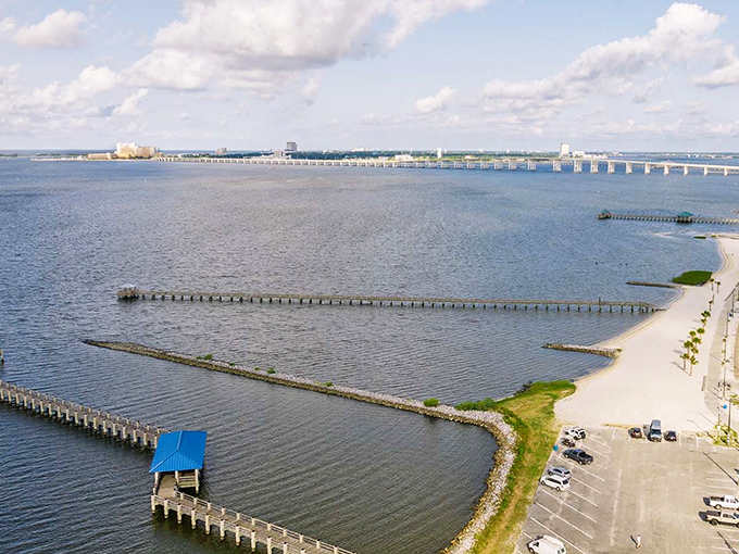 The Biloxi Bay Bridge stretches like a concrete welcome mat, inviting you to Ocean Springs' sandy shores and gentle waters. Paradise with parking.