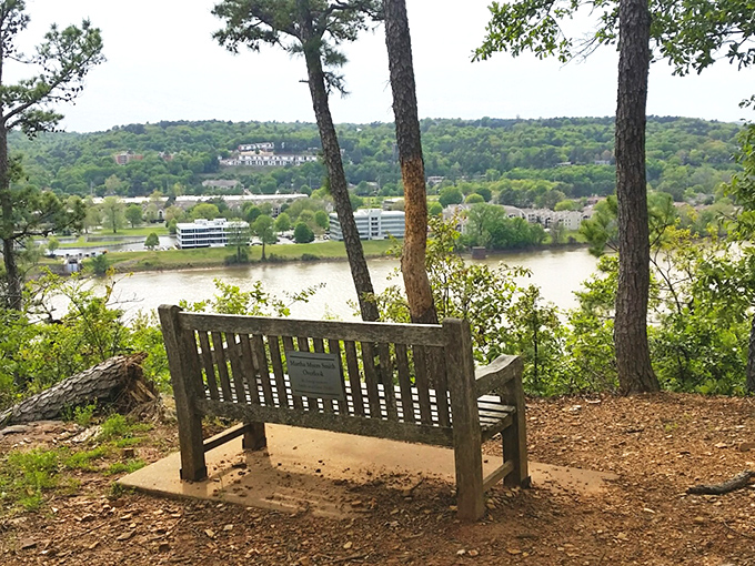 A weathered bench perched on Emerald Park's bluffs offers a contemplative spot to rest while overlooking the Arkansas River below.