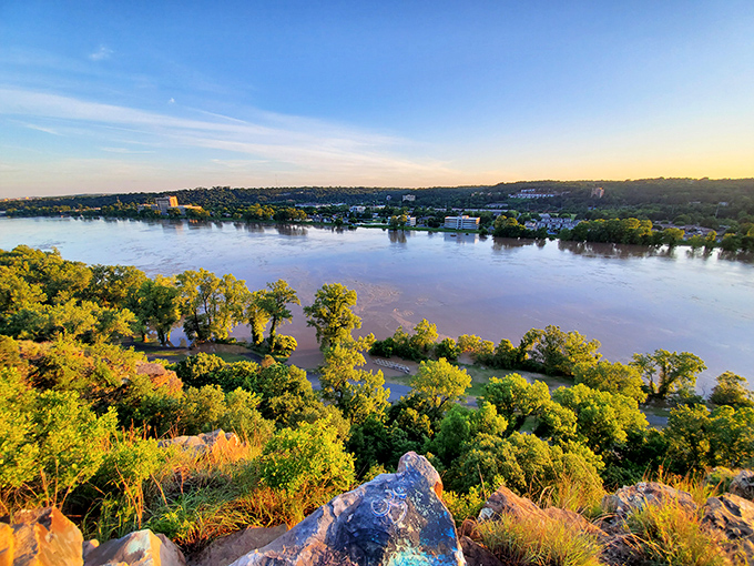 Golden hour transforms Emerald Park's panoramic river view into a breathtaking canvas of light, water, and lush Arkansas greenery.