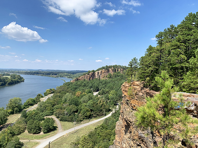 Dramatic sandstone bluffs rise 200 feet above the Arkansas River, showcasing the spectacular vistas that make Emerald Park North Little Rock's hidden treasure.