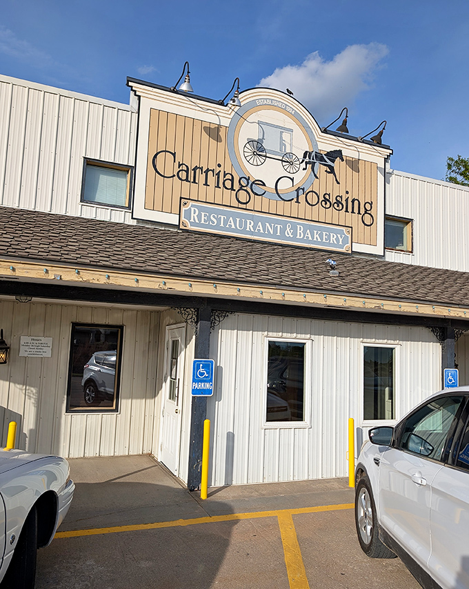The iconic Carriage Crossing sign welcomes hungry travelers like a beacon of comfort food hope in the Kansas countryside.