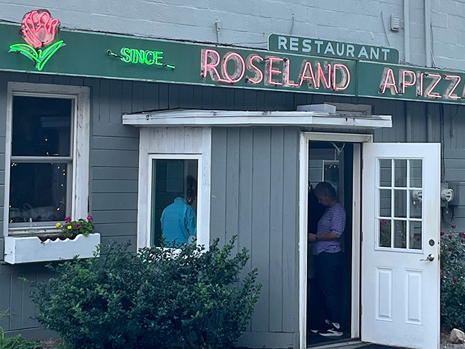 The unassuming gray building with its vintage green sign has been luring pizza pilgrims for generations. Connecticut's best-kept secret hides in plain sight.