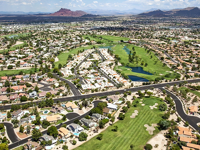 A stunning aerial view of downtown Mesa, Arizona showcases the city's modern skyline with buildings, palm-lined streets, and well-planned urban layout.