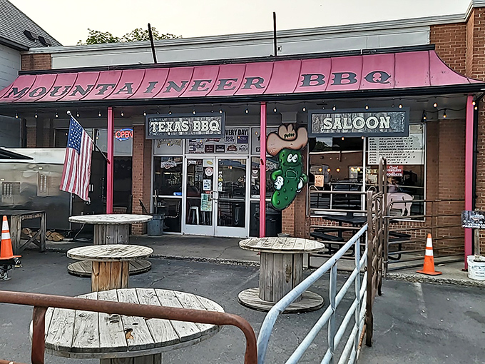 Dusk settles over Mountaineer BBQ, where the American flag waves proudly and wooden spools await the next round of brisket enthusiasts.