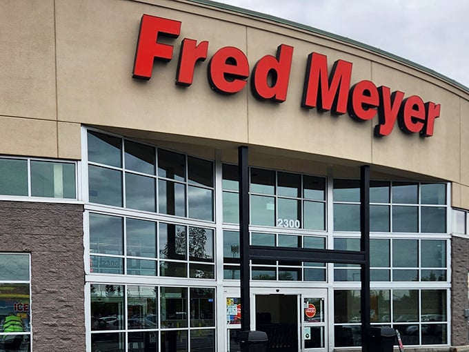 The iconic red Fred Meyer sign welcomes Alaskans like a beacon of retail hope against the often-gray Anchorage sky. Shopping adventure begins here!