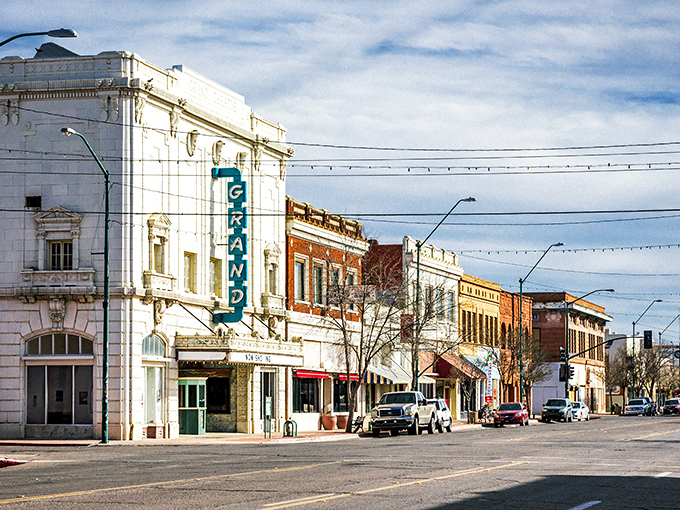 The Grand Theatre's vertical teal sign beckons like a neon lighthouse guiding culture-seekers through Douglas's historic district.