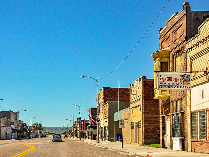 The Branding Iron restaurant beckons hungry travelers with promises of hearty Nebraska fare&mdash;proof that culinary treasures often hide in plain sight.