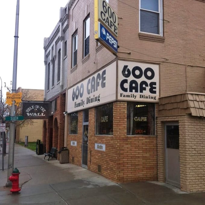 The corner brick building with its vintage signage promises "Family Dining" &ndash; a humble exterior hiding breakfast treasures that locals have cherished for generations.