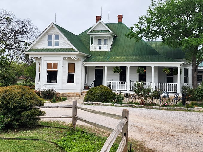 Hanging plants and manicured shrubs soften the spooky vibes of this historic home-turned-restaurant, proving even horror needs a touch of Texas hospitality.