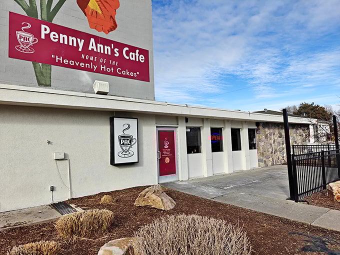 The iconic pink signage of Penny Ann's Cafe stands out against Utah's blue sky, promising "Heavenly Hot Cakes" that live up to their divine billing.