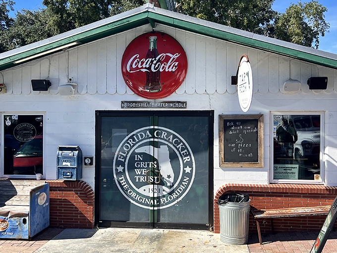 The iconic white exterior with its vintage Coca-Cola sign and "In Grits We Trust" motto isn't just inviting&mdash;it's practically a declaration of Southern food philosophy.