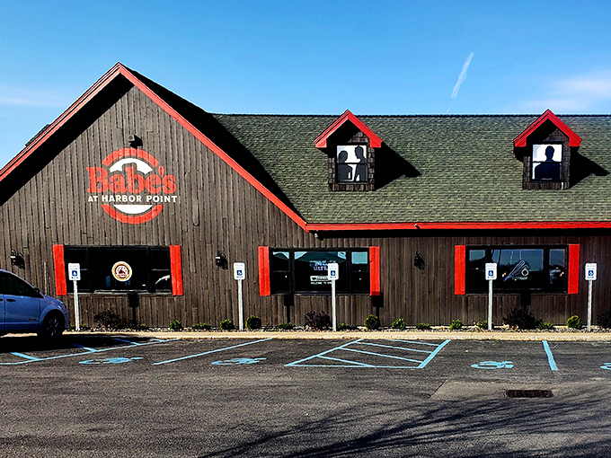 The gray building with bold red trim stands like a beacon of culinary promise against the blue Utica sky. Harbor Point's hidden gem awaits.
