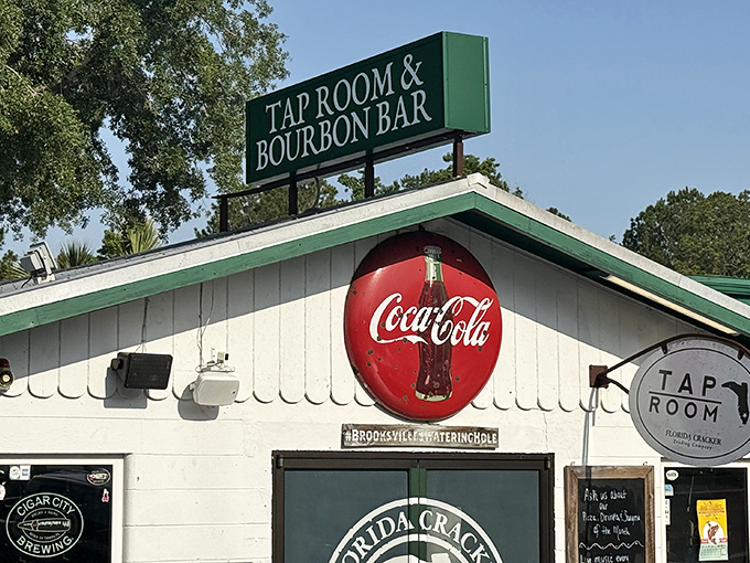 The iconic exterior of Florida Cracker Kitchen beckons with its vintage Coca-Cola sign and "Tap Room & Bourbon Bar" marquee &ndash; Southern hospitality with a splash of spirits.