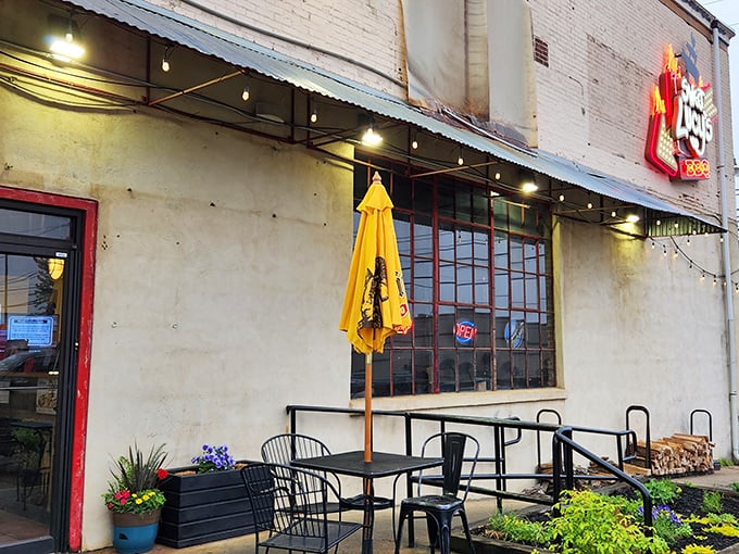 The unassuming exterior of Sweet Lucy's Smokehouse promises no frills, just thrills – that yellow umbrella practically waving you in like a BBQ beacon.