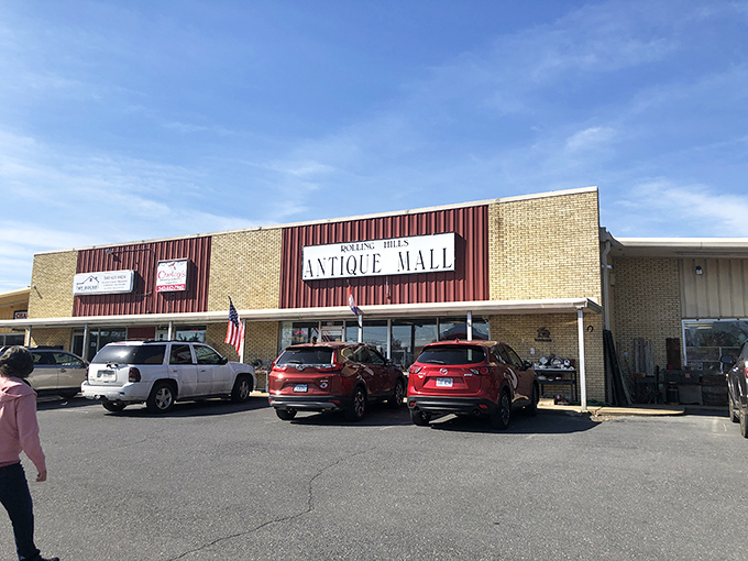 The unassuming exterior of Rolling Hills Antique Mall hides a universe of treasures within, like a time-travel portal disguised as a strip mall storefront.