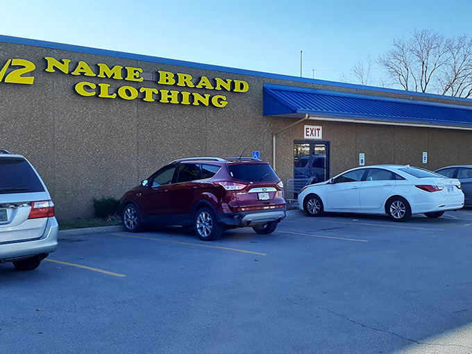 The bright yellow signage of Half of Half Name Brand Clothing stands out against the blue roof trim, beckoning bargain hunters like a fashion lighthouse in Lenexa.