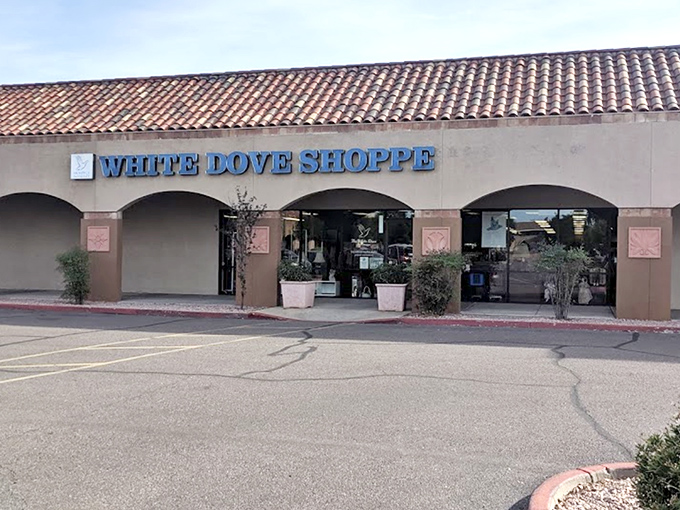 The White Dove Thrift Shoppe welcomes bargain hunters with its distinctive blue signage and Spanish-style roof—thrifting paradise awaits!