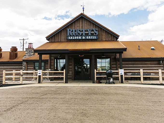 The rustic wooden exterior of Rusty's stands like a prairie oasis, promising comfort and satisfaction to weary travelers and hungry locals alike.